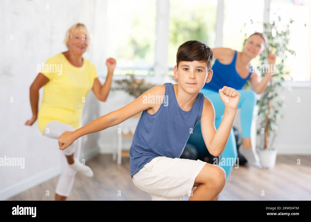 Happy preteen boy practicing dance positions during workout session ...