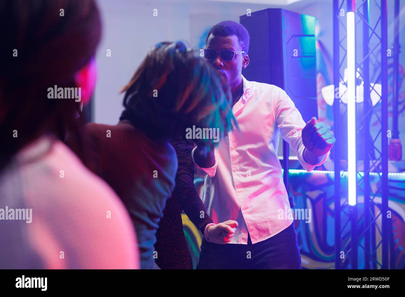 Cool african american man partying and dancing in nightclub illuminated ...
