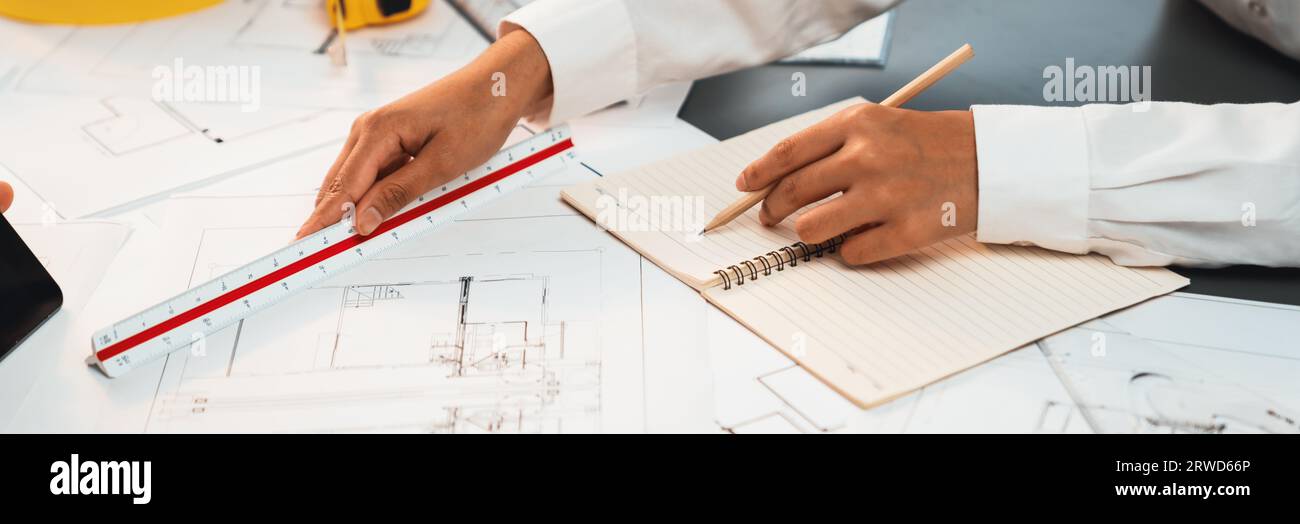 Architect or engineer working on building blueprint, contractor ...