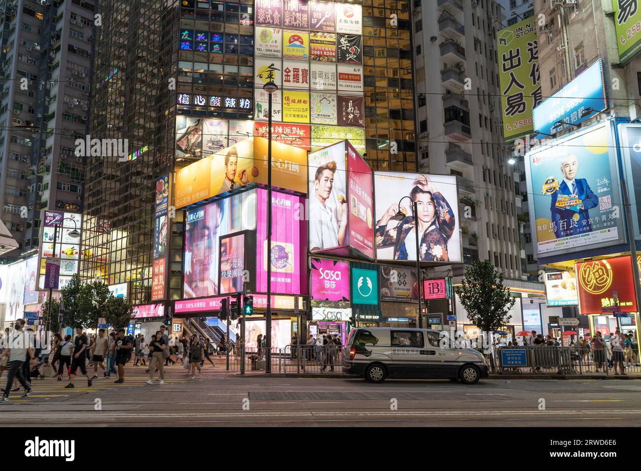 Large shopping area of Causeway Bay with a bust road and lots of ...