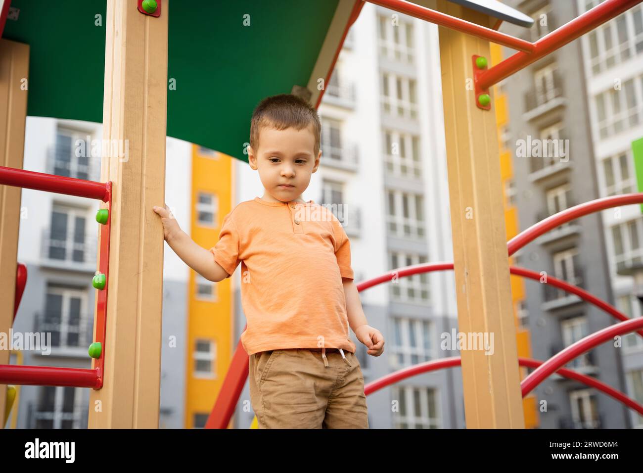 Cute toddler boy two or three years old is playing on the playground in ...