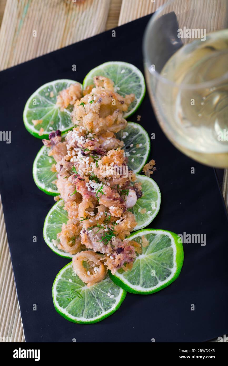Battered calamari and cuttle with lime Stock Photo - Alamy