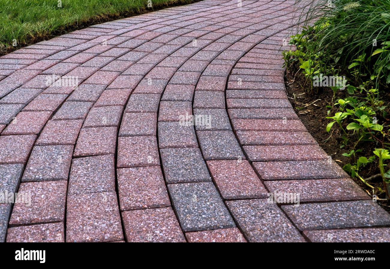 Brick pavers arranged in a curving pattern Stock Photo - Alamy