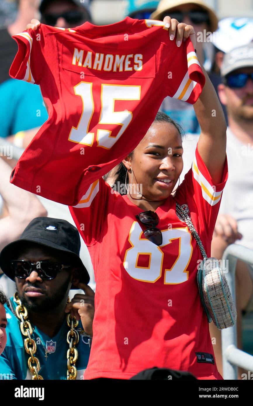 A Kansas City Chiefs fan holds up a quarterback Patrick Mahomes jersey ...
