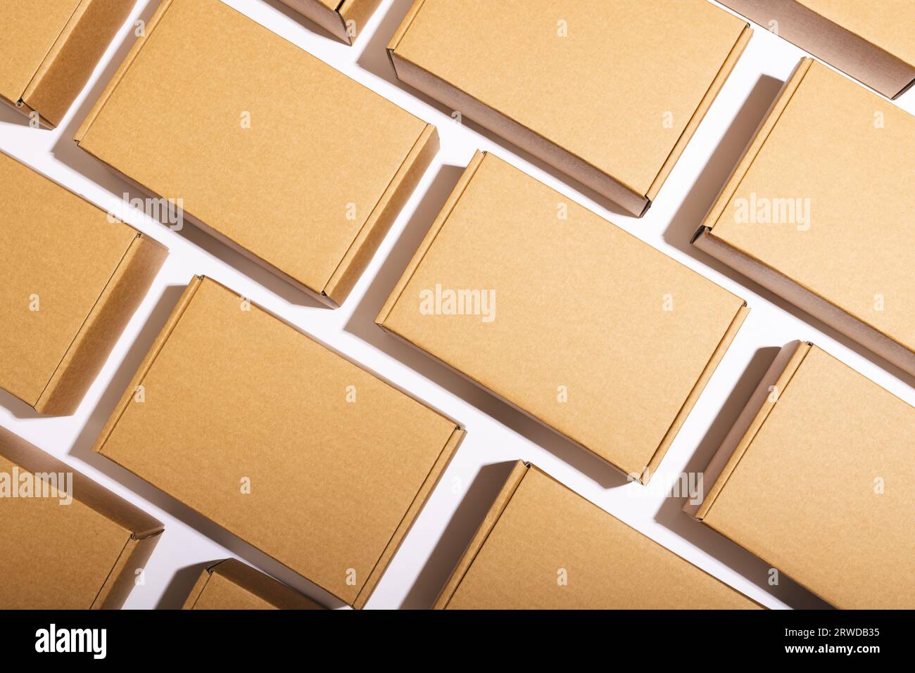 Rows of cardboard gift boxes with copy space over white background ...