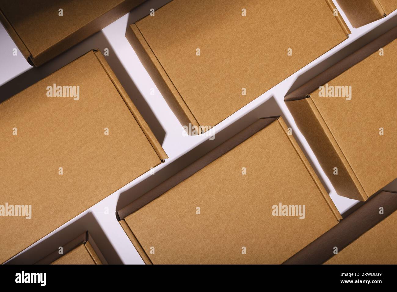 Rows of cardboard gift boxes with copy space over white background ...