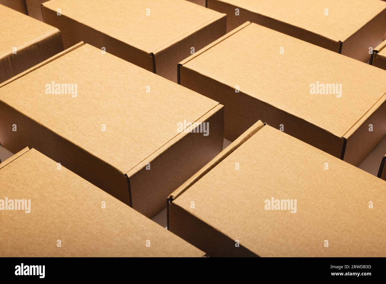 Rows of cardboard gift boxes with copy space over white background ...