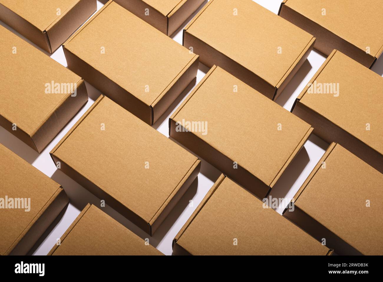 Rows of cardboard gift boxes with copy space over white background ...