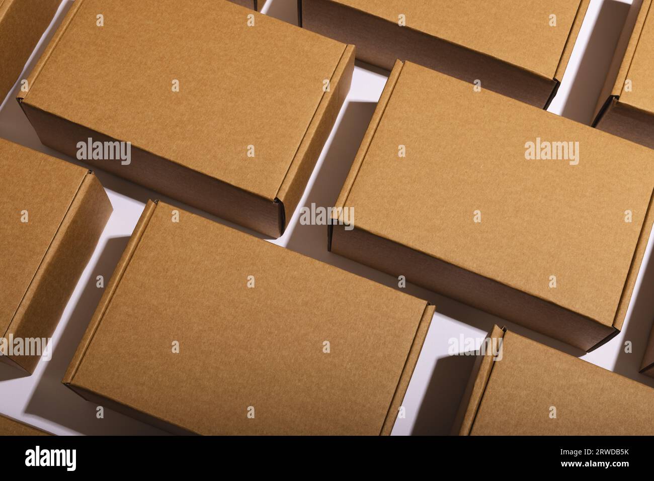 Rows of cardboard gift boxes with copy space over white background ...