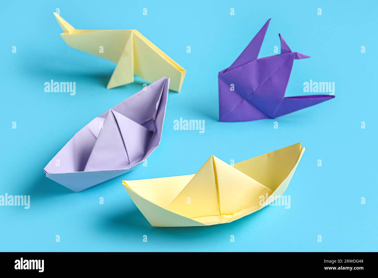 Colorful origami boats and animals on purple background Stock Photo - Alamy