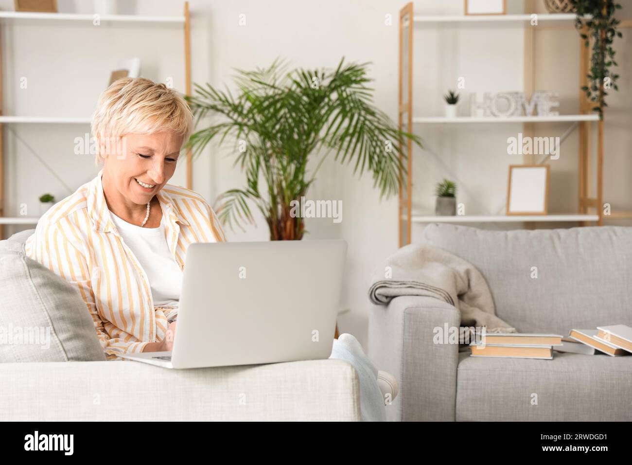 Mature woman learning English language online at home Stock Photo - Alamy