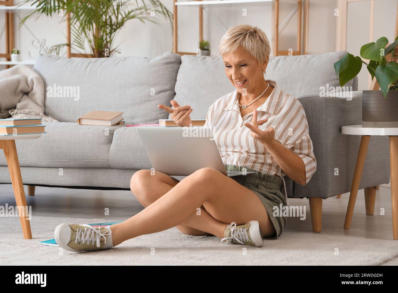 Mature woman learning English language online at home Stock Photo - Alamy