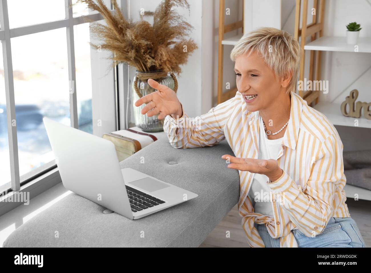 Mature woman learning English language online at home Stock Photo - Alamy