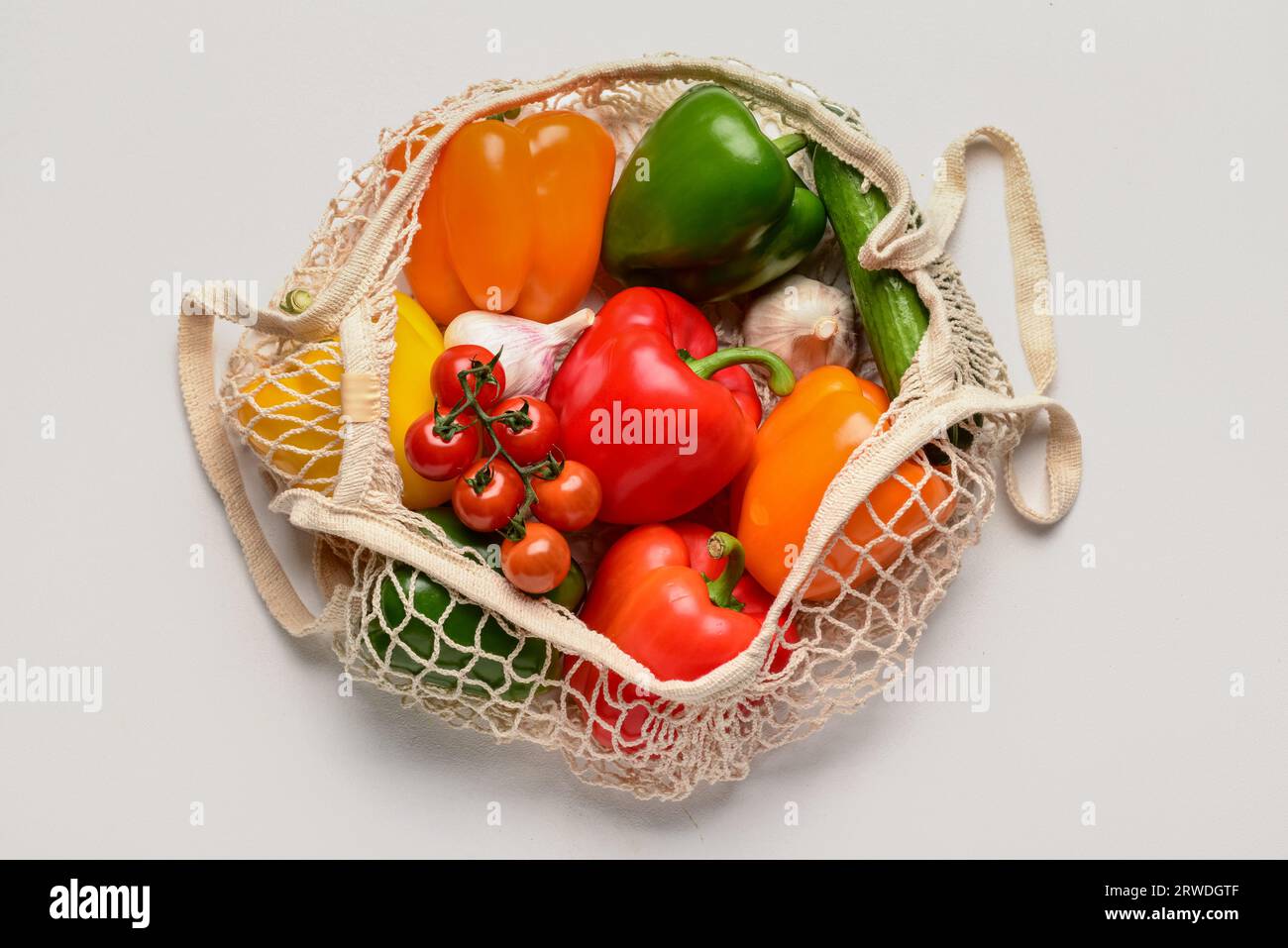 Mesh bag with different fresh vegetables on white background Stock ...