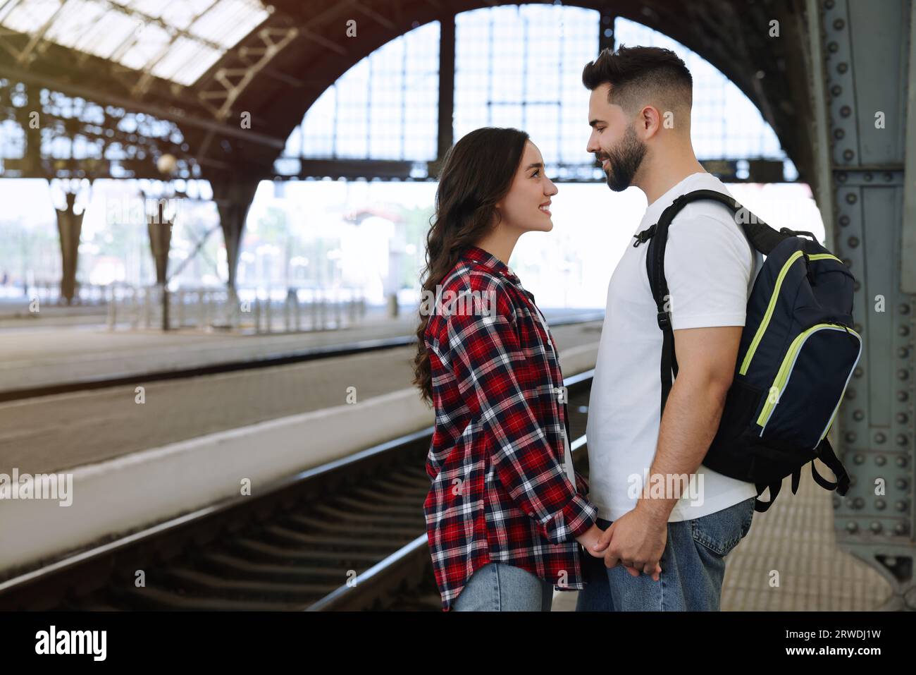 Long-distance relationship. Beautiful couple on platform of railway ...