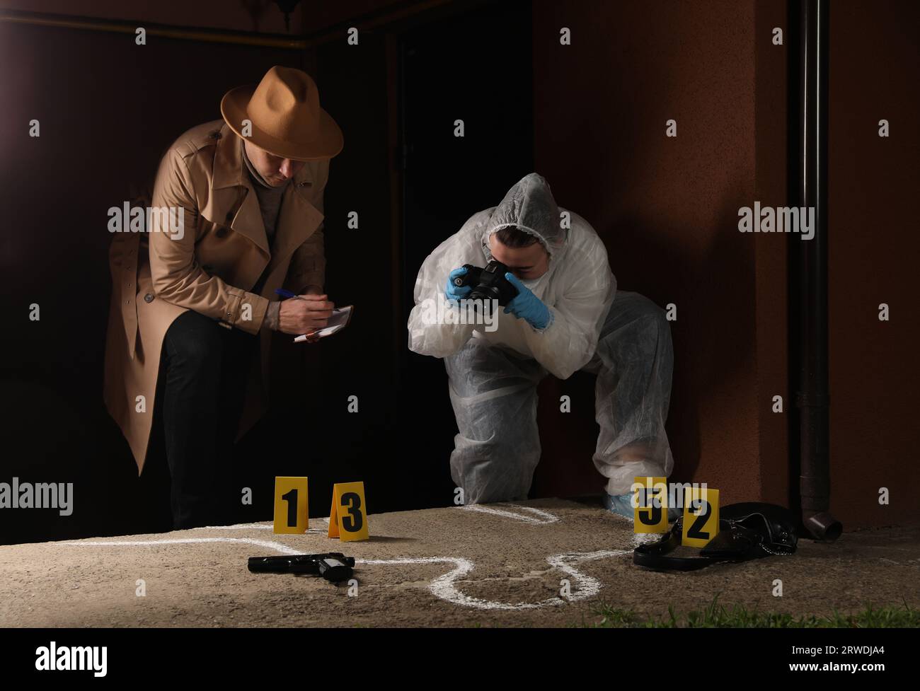 Investigator and criminologist working at crime scene outdoors in evening Stock Photo - Alamy