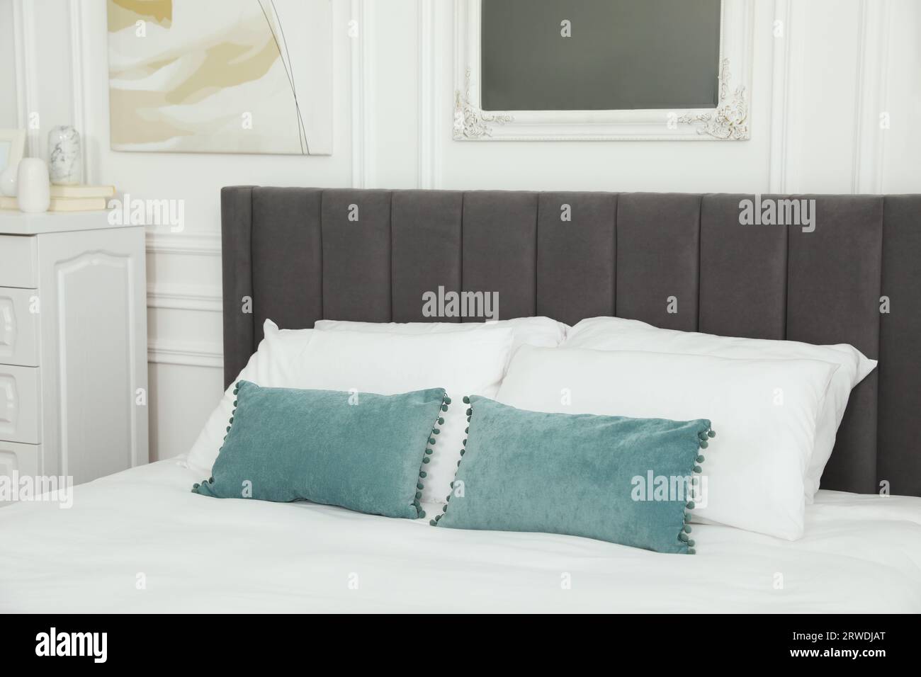 Large comfortable bed with cushions in bedroom. Interior design Stock ...