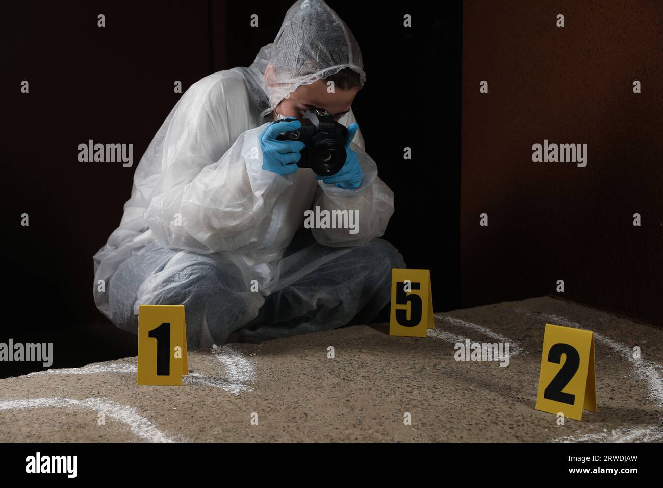 Criminologist in protective suit working at crime scene outdoors Stock Photo - Alamy