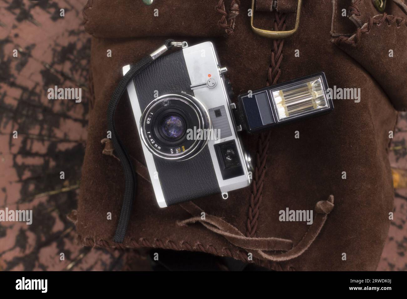 analog photo camera with flash on a brown backpack Stock Photo - Alamy