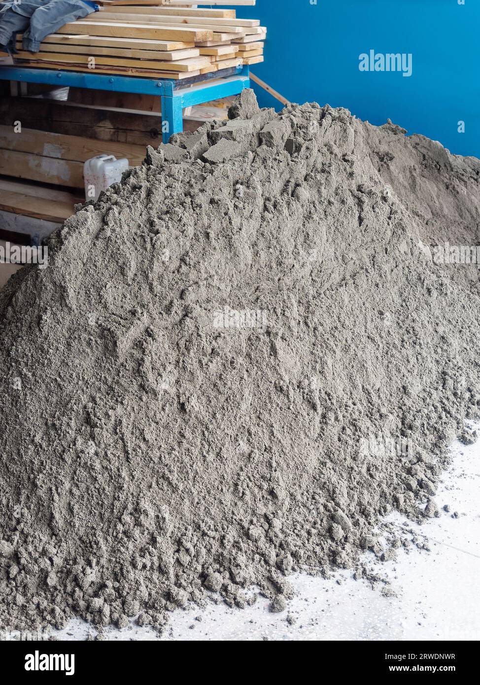 Pile of gray sand is poured inside room. Construction material. View ...