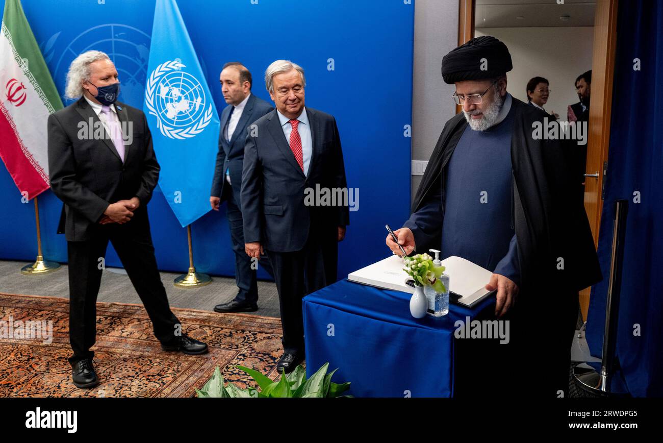President of Iran Ebrahim Raisi signs a guest book as he meets with ...