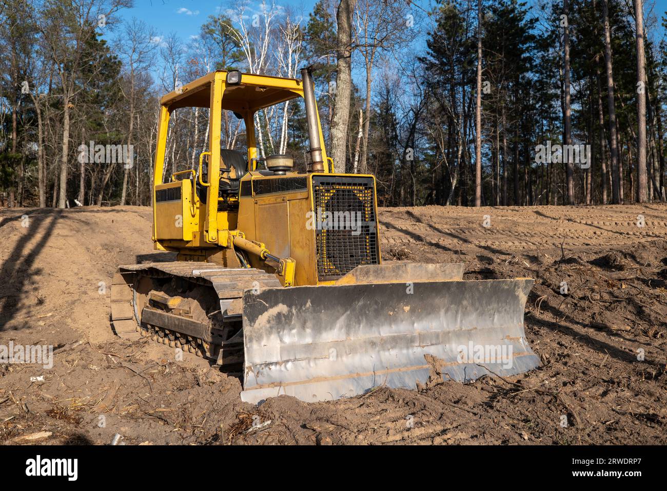 Older working Bulldozer with front blade and hydraulics power, parked ...