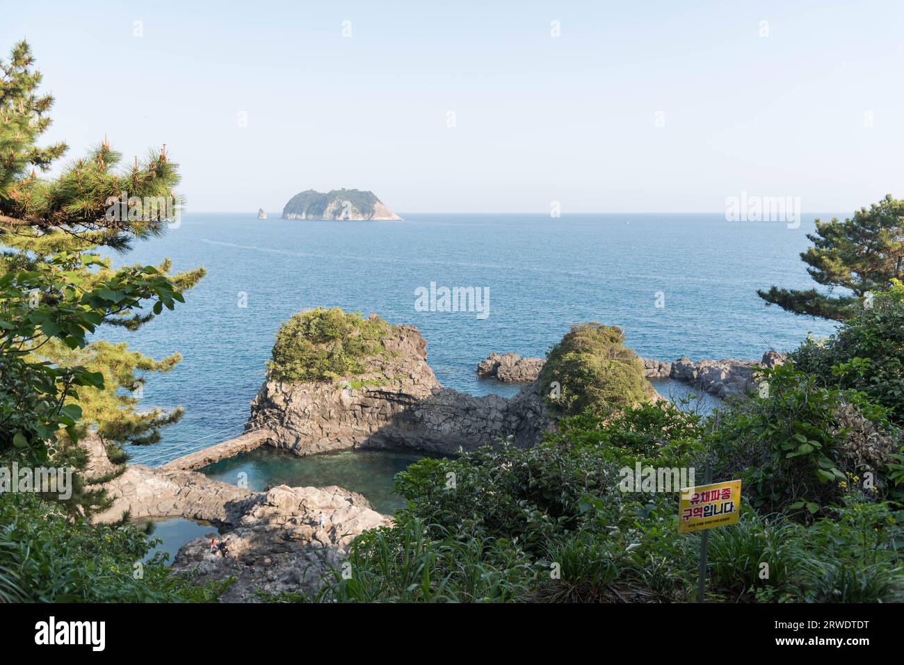 Seonnyeotang, a natural pool on the coast of Jeju, with the sea in the ...