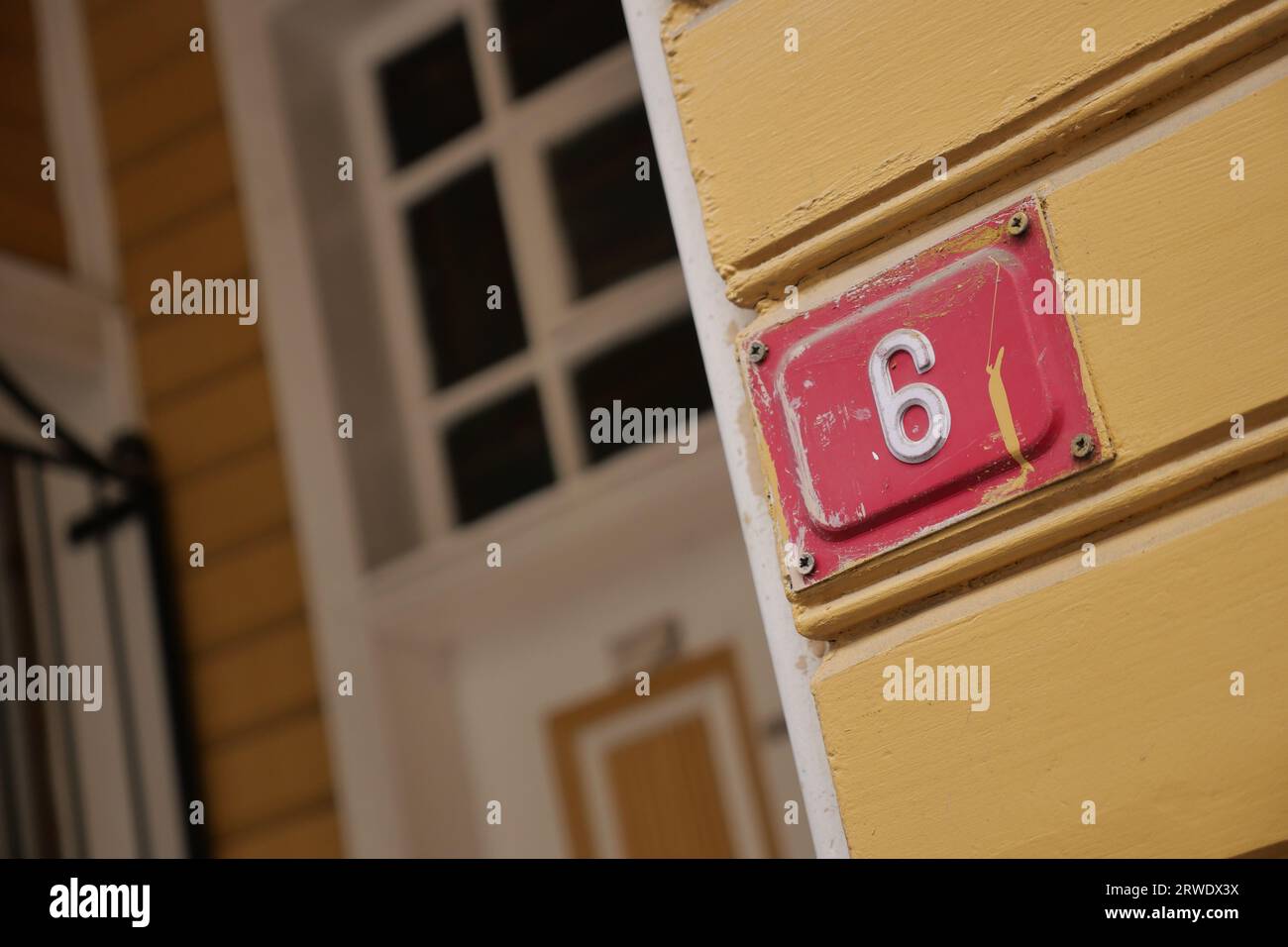 house number six. Decorative lettering on a brick wall Stock Photo - Alamy