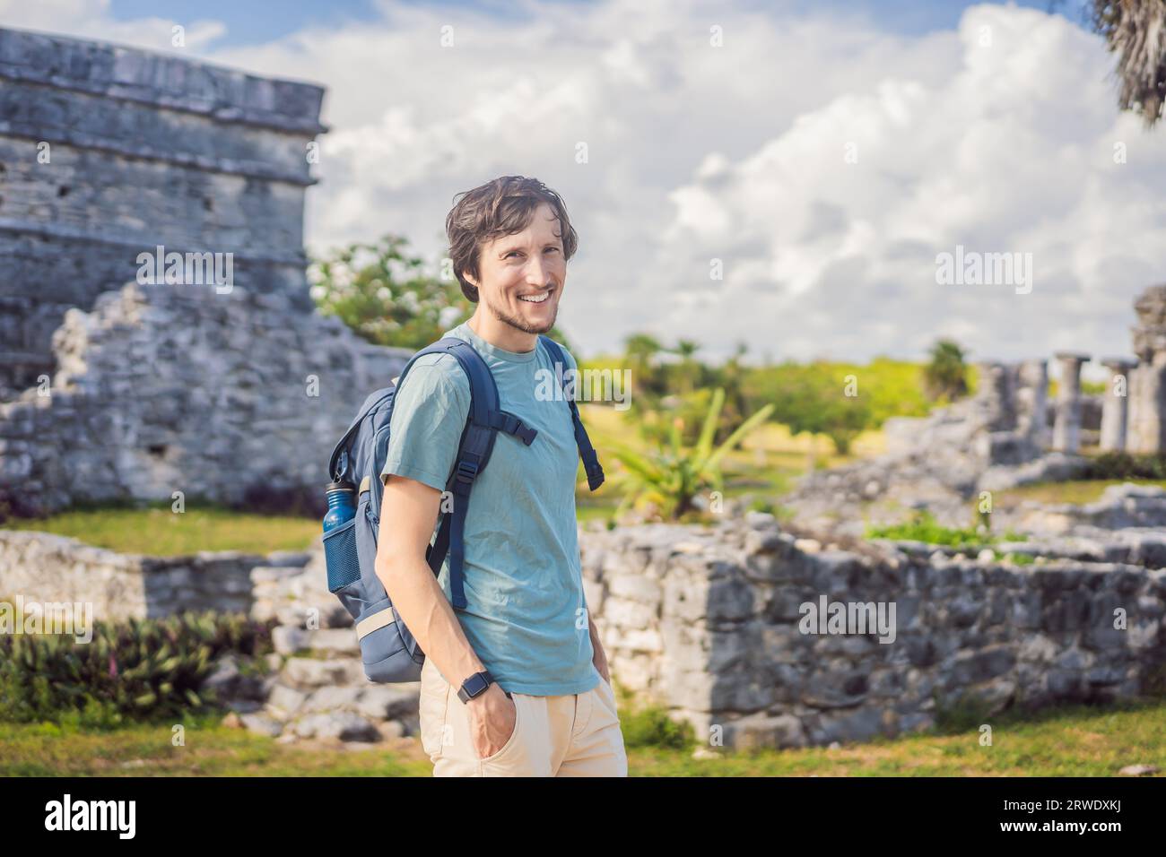 Male tourist enjoying the view Pre-Columbian Mayan walled city of Tulum ...