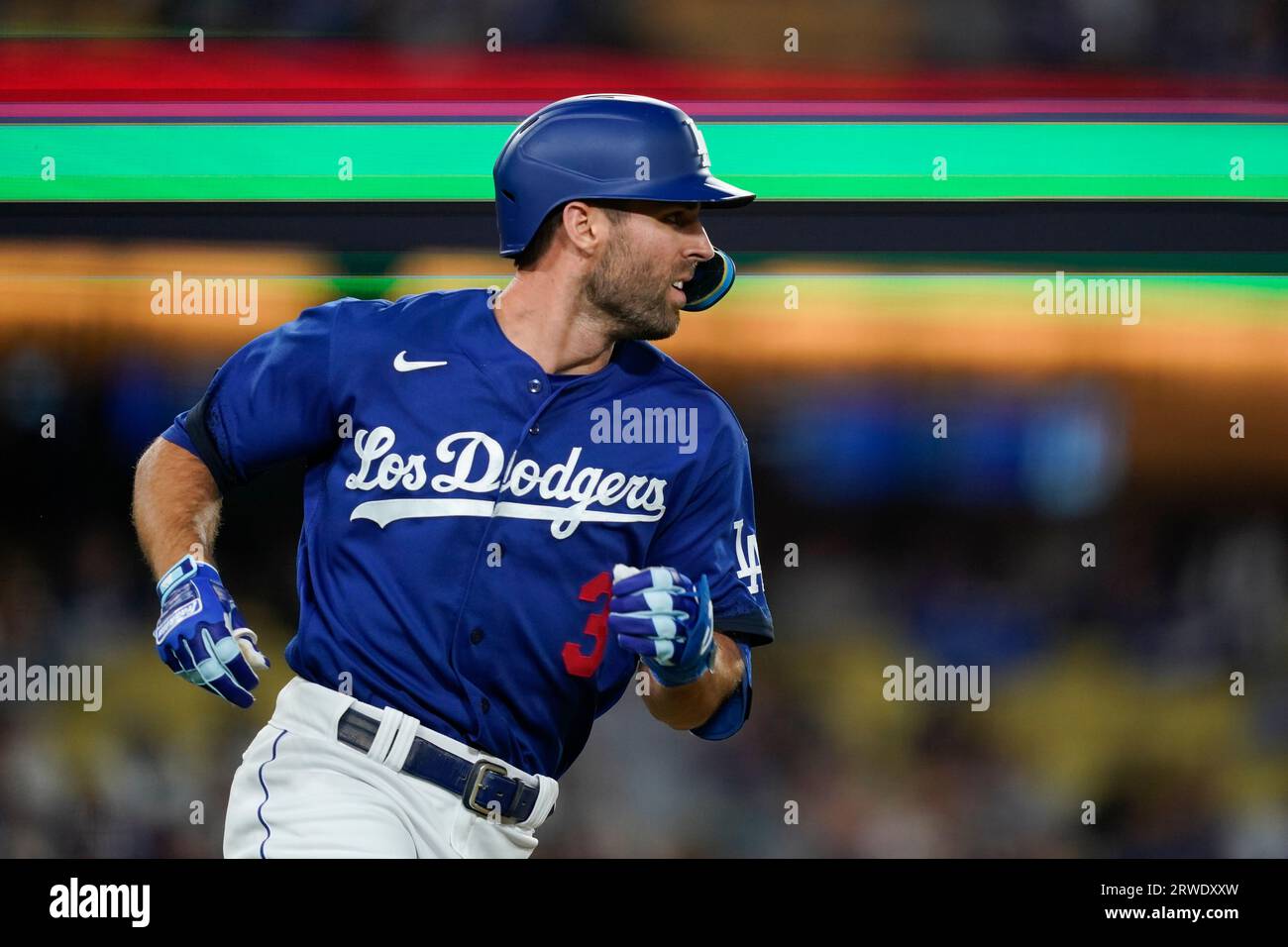 Los Angeles Dodgers' Chris Taylor watches while running after flying ...