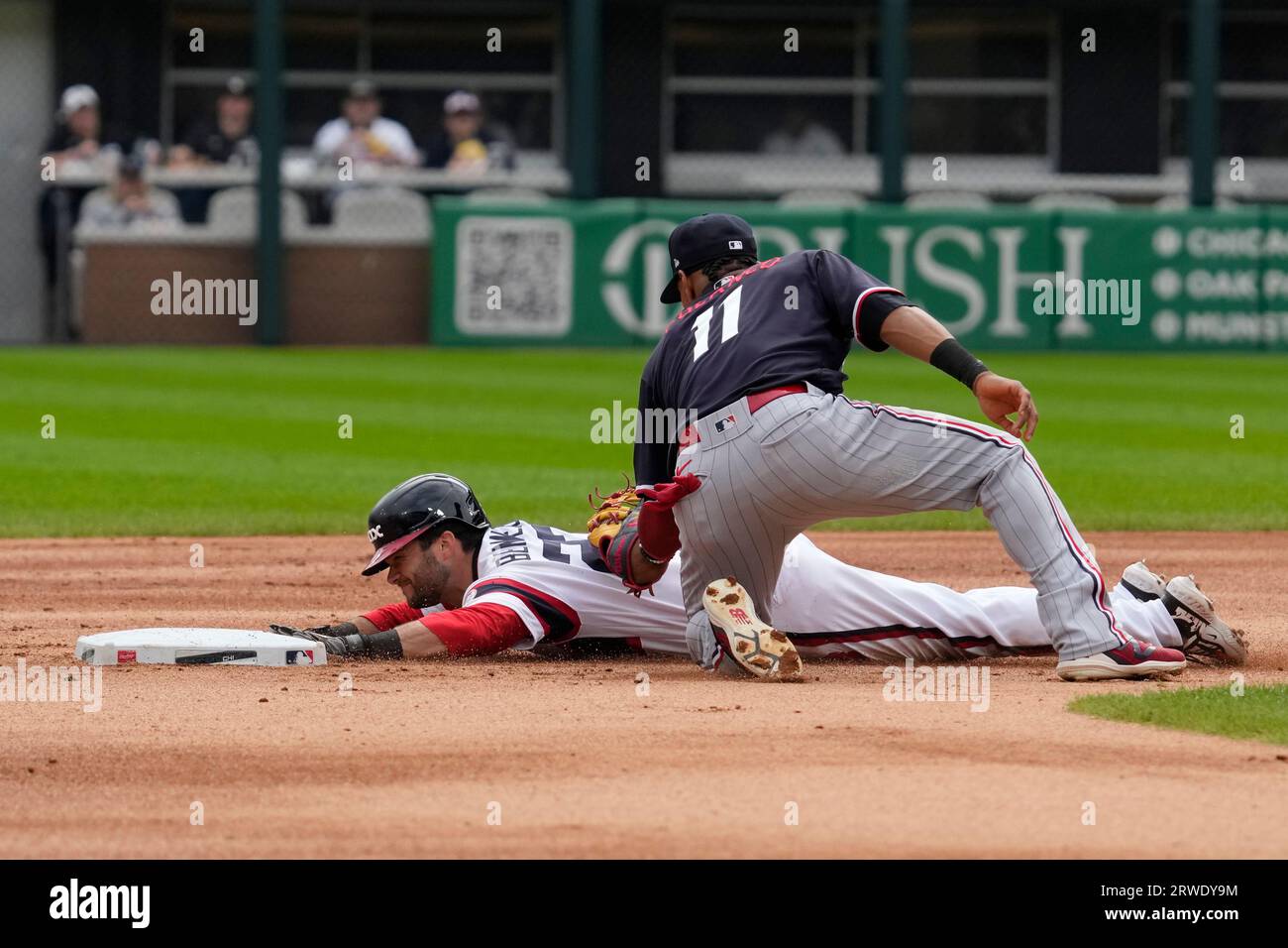 Chicago White Sox's Andrew Benintendi, left, is tagged out by Minnesota ...