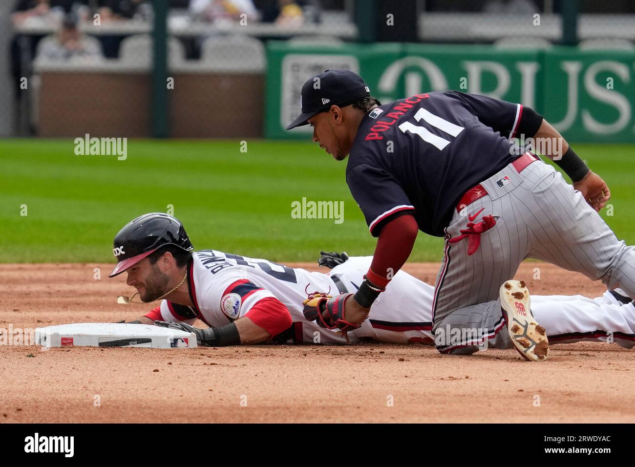 Chicago White Sox's Andrew Benintendi, left, is tagged out by Minnesota ...