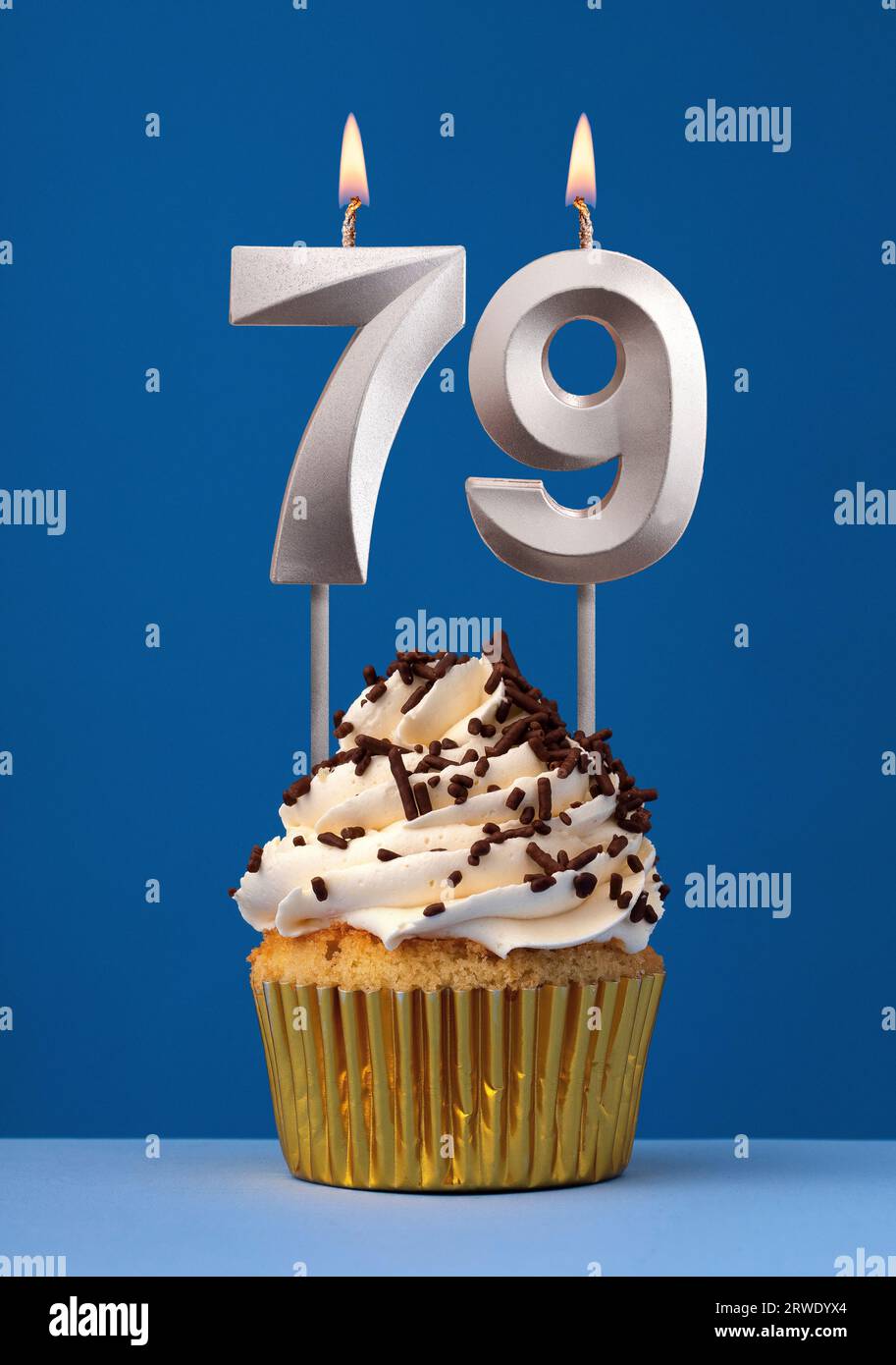 Burning candle number 79 - Birthday card with cake on blue Background ...