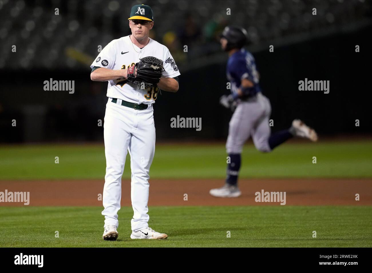 Oakland Athletics pitcher JP Sears, front, reacts after allowing a two ...