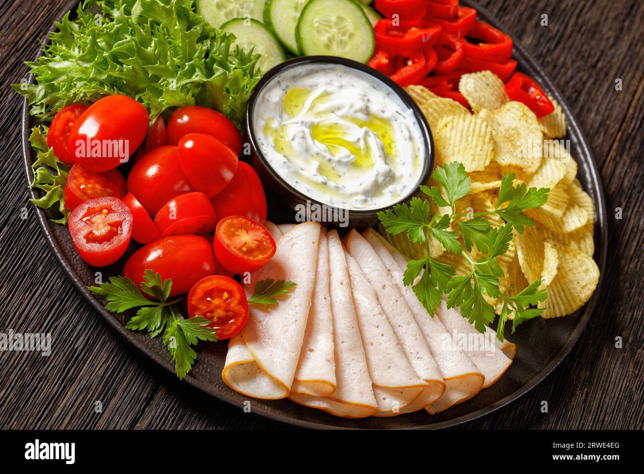 sliced ham, potato chips, leafy greens and vegetables snack platter ...