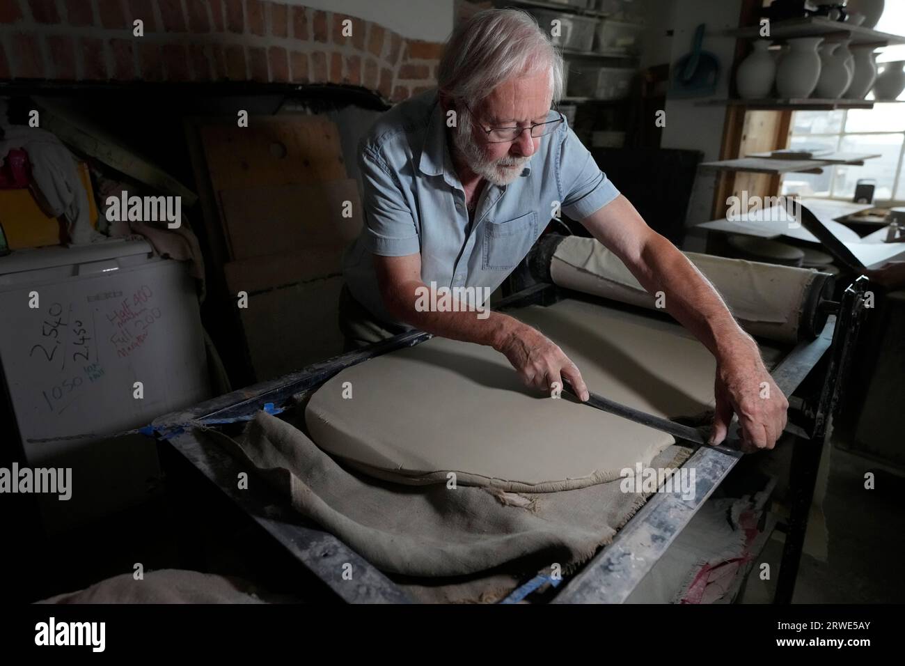 Ned Heywood measures clay during the making of an English Heritage Blue ...