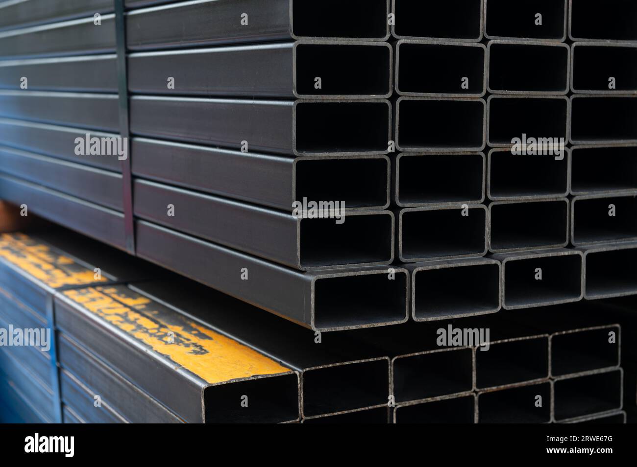 Stack of square metal pipe background Stock Photo - Alamy