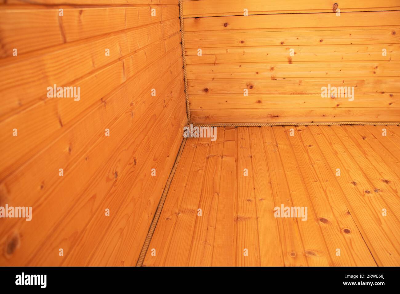 A room made of wood and a wooden corner from the ceiling and wall ...