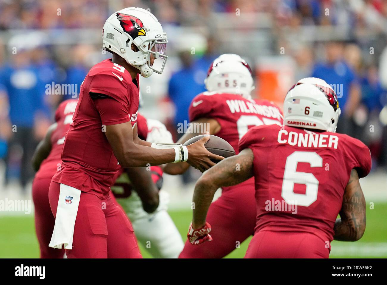 Arizona Cardinals quarterback Joshua Dobbs, left, hands the ball off to ...