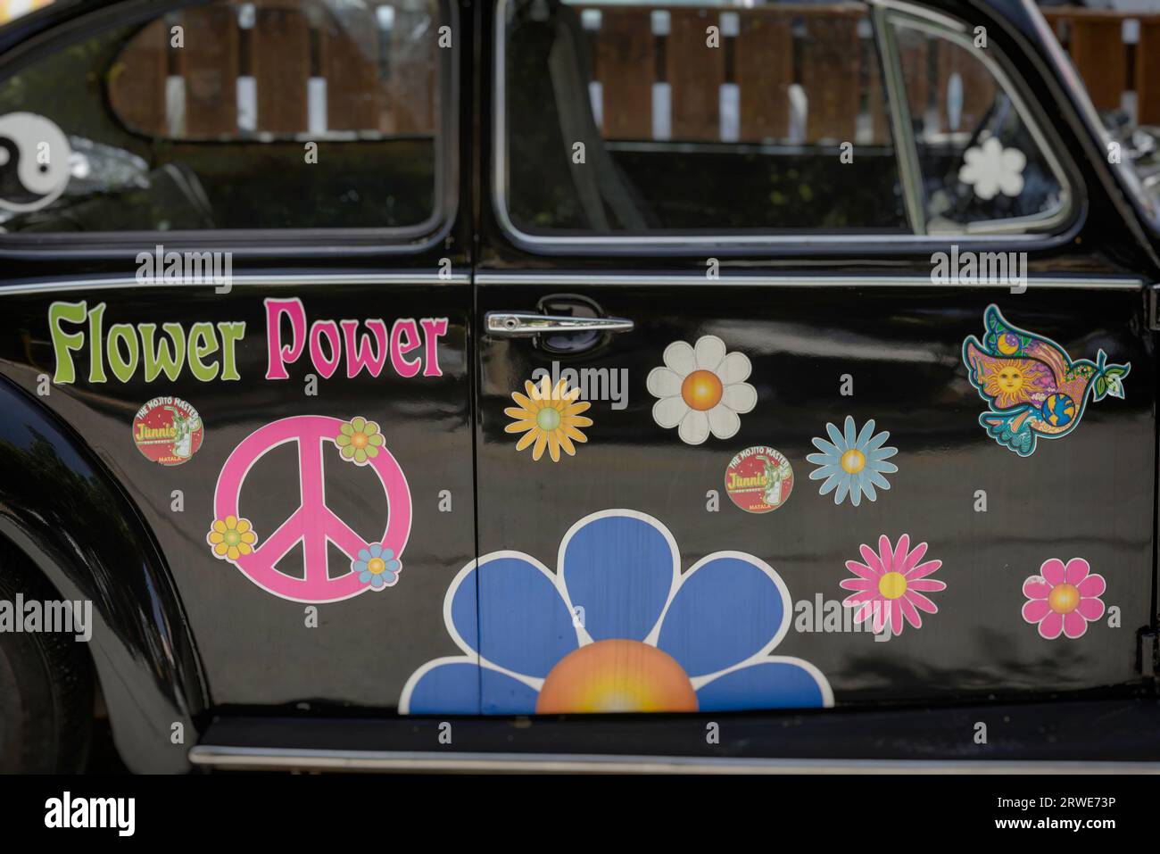 Flowers and peace symbols on car doors in Matala, Greece Stock Photo ...
