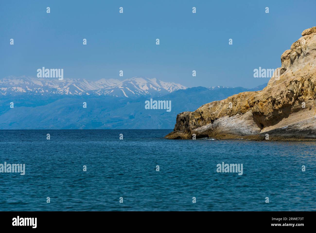 The island of Crete with snow-capped mountains, blue sky, sea, Matala ...