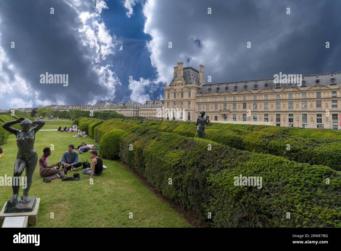 Young people on the green spaces in front of the Louvre, Paris, France ...