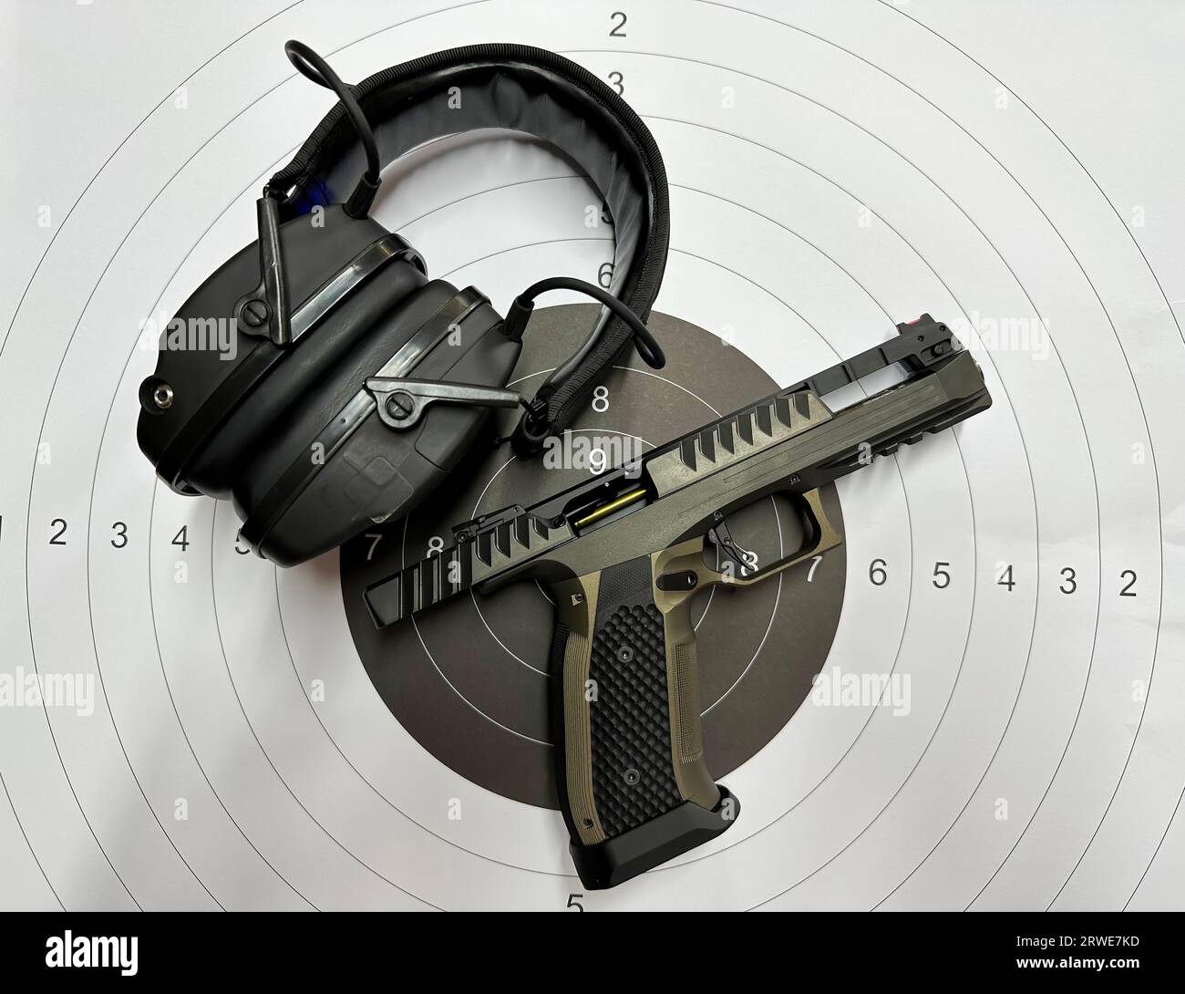 Handgun and Headphone Lying on a Shooting Target in Switzerland Stock ...