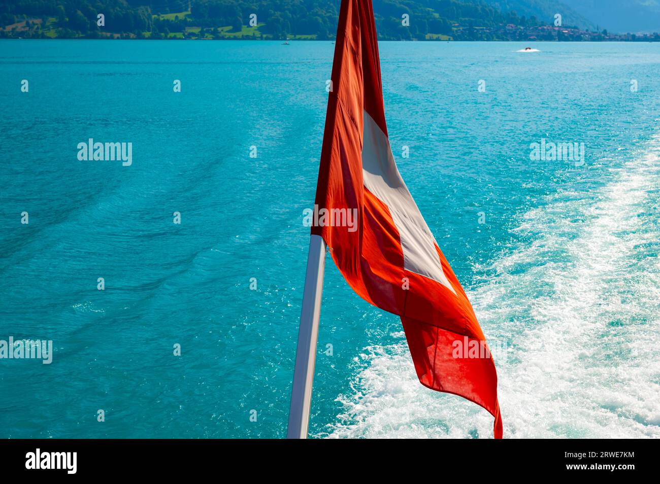 Swiss Flag over Lake Brienz in a Sunny Day in Interlaken, Bernese ...