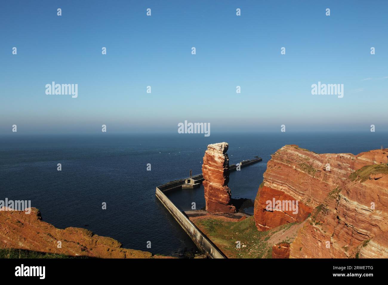 The steep coast of Helgoland with Helgoland's landmark, the Lange Anna ...