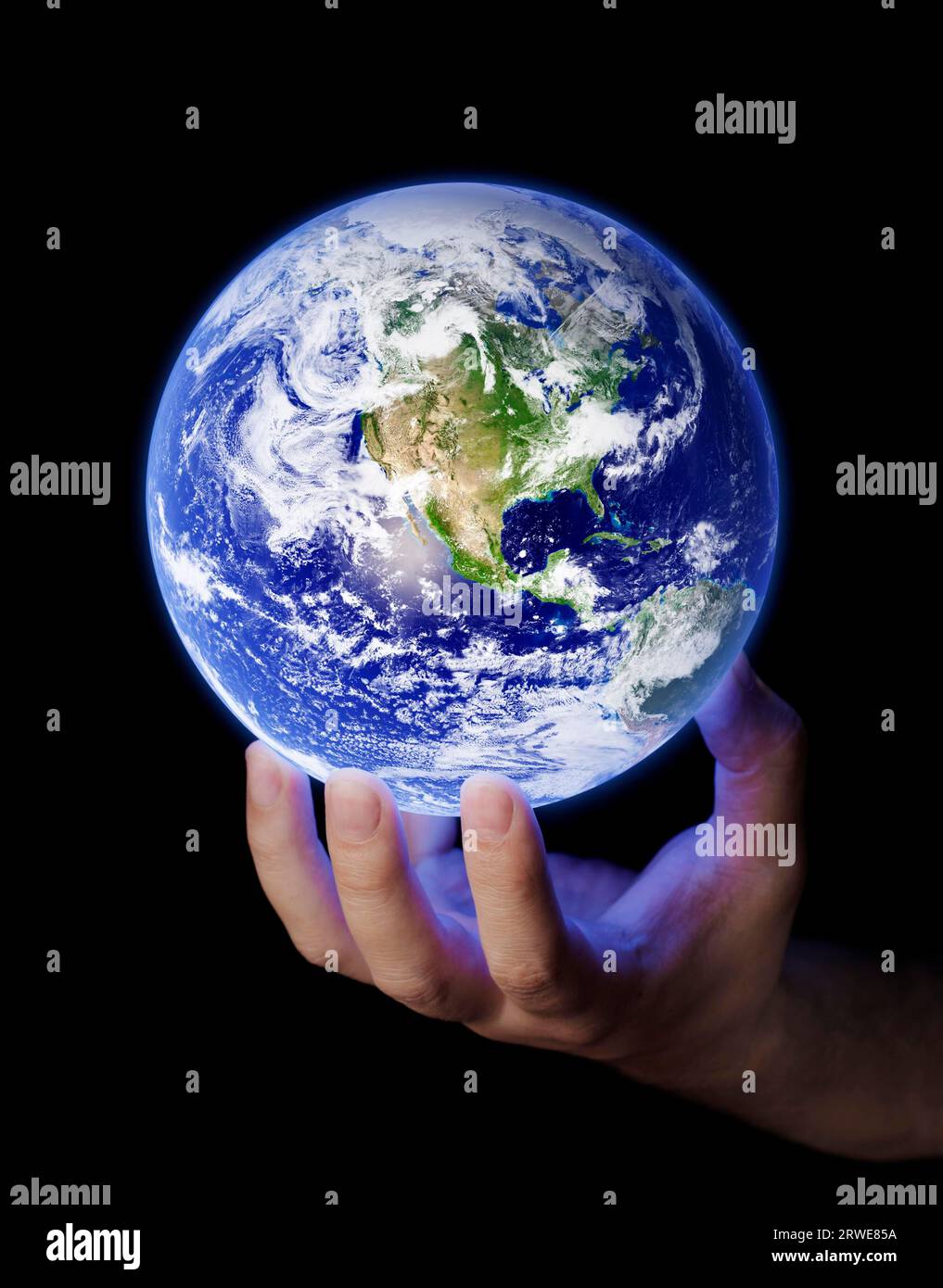 Man holding a glowing earth in his hand. Earth image provided by NASA ...
