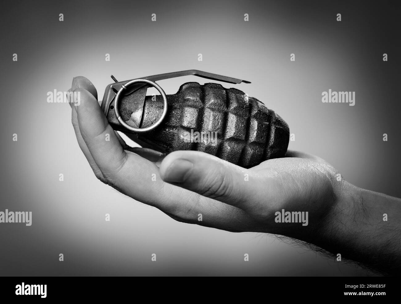 Man holding a hand grenade on his hand Stock Photo - Alamy
