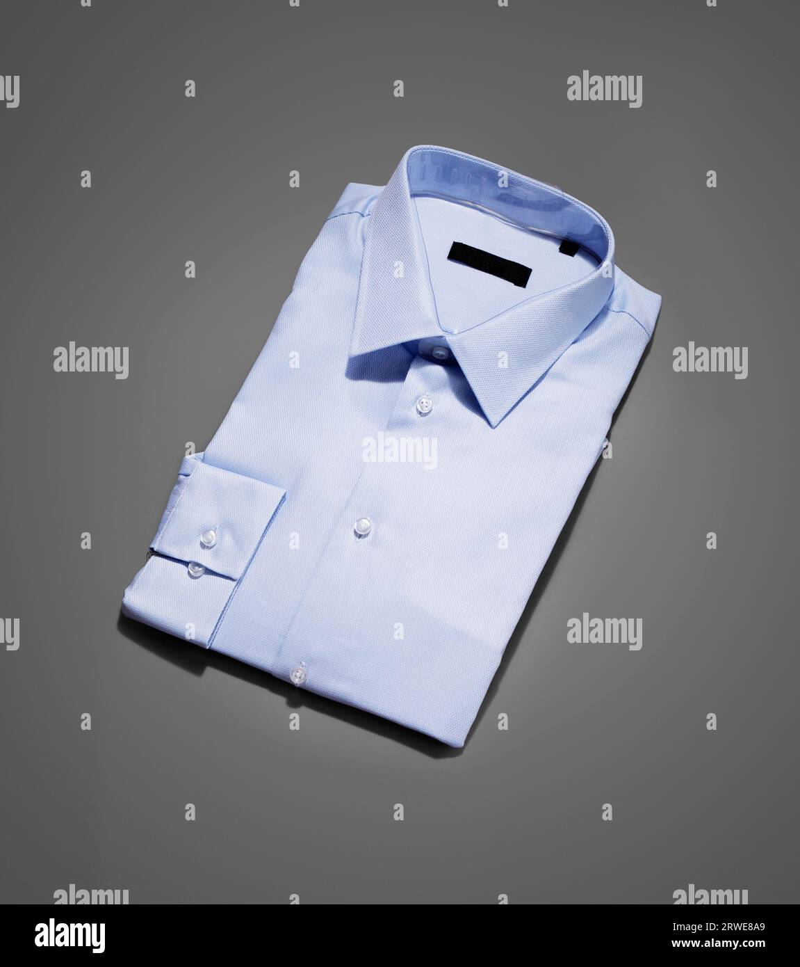 Mens new blue dress shirt on grey background Stock Photo - Alamy