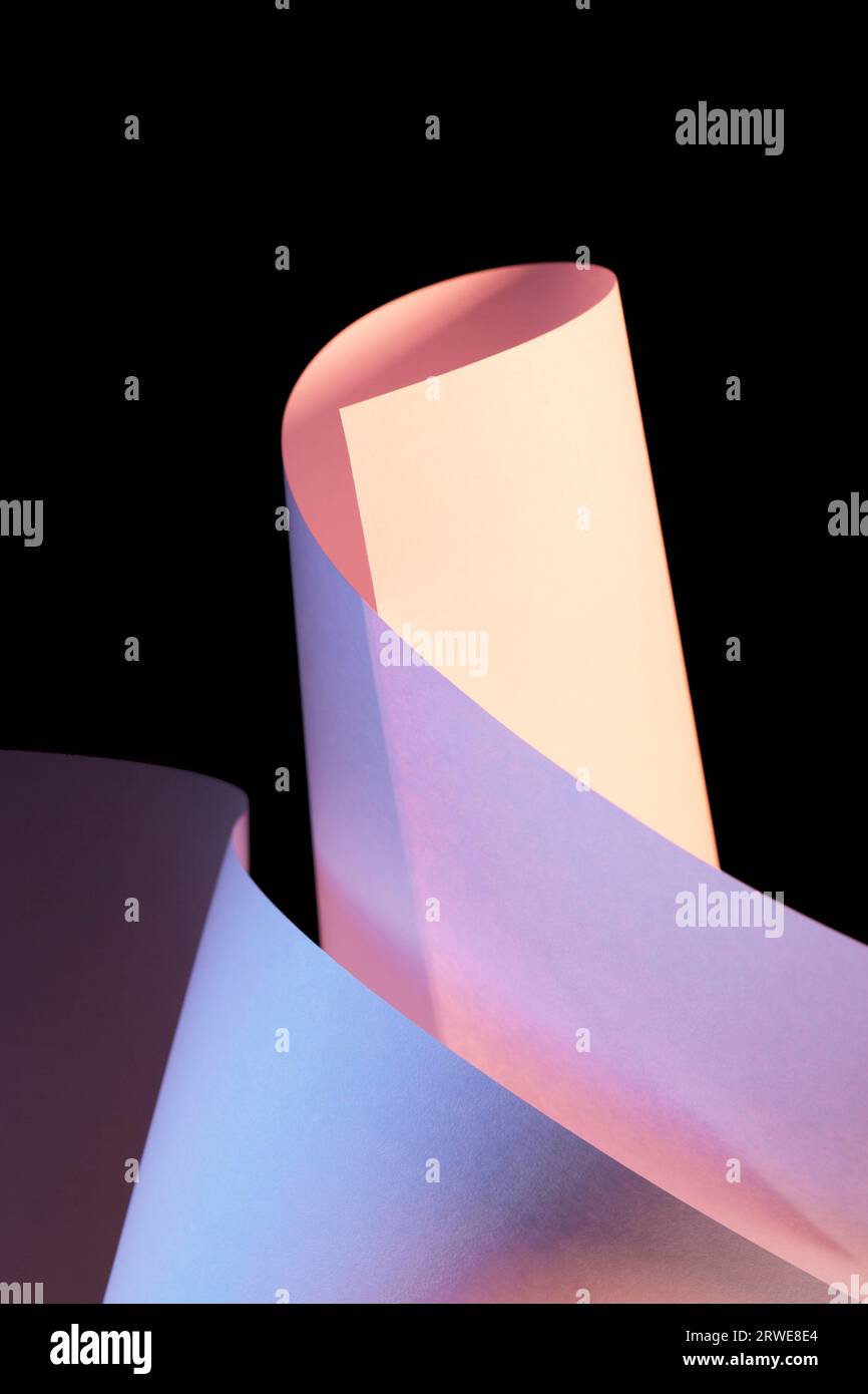 Abstract image of white paper sheets photographed under color lights ...