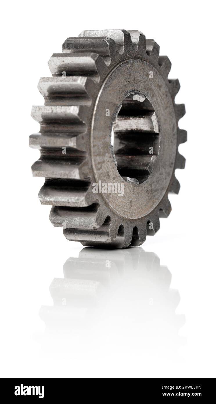 Old metallic cog gear wheel on white, with natural reflection. Short ...